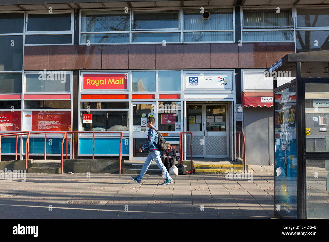 Man walking past a Royal Mail sorting office in Whitechapel London ...