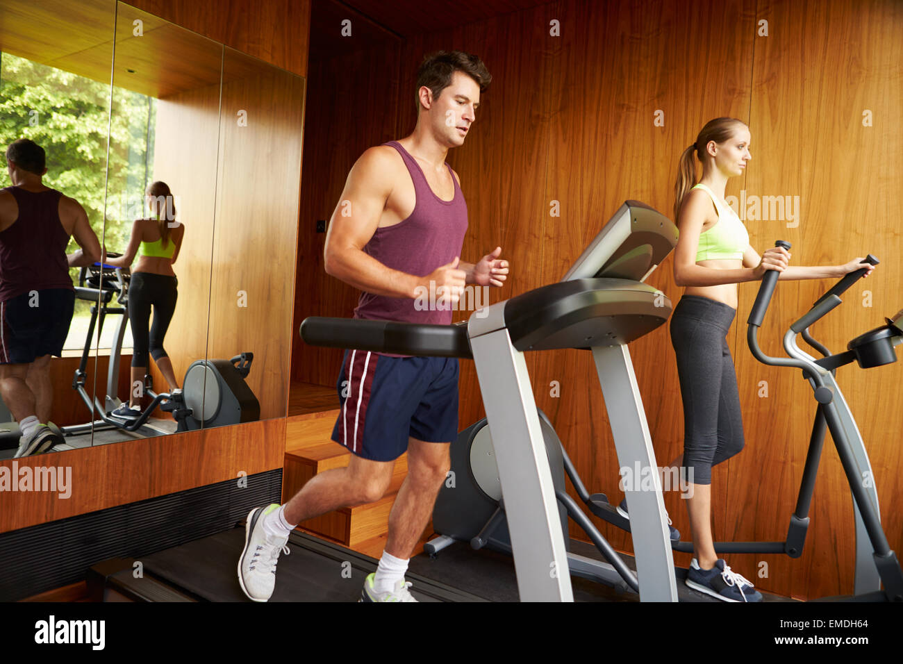 Couple Exercising Together In Home Gym Stock Photo - Alamy