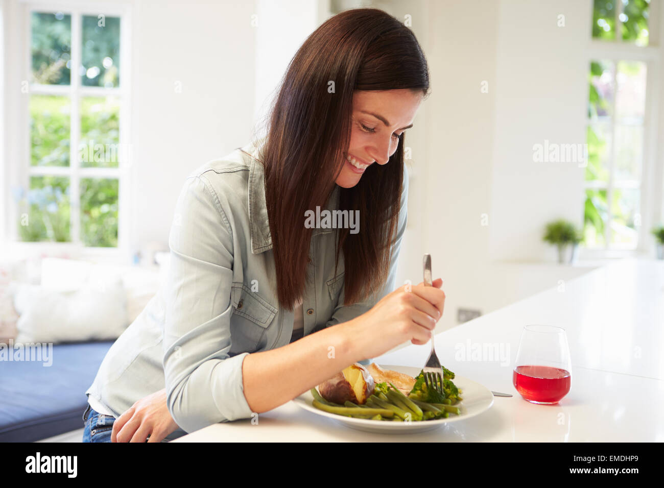Woman Eating Healthy Meal In Kitchen Stock Photo - Alamy