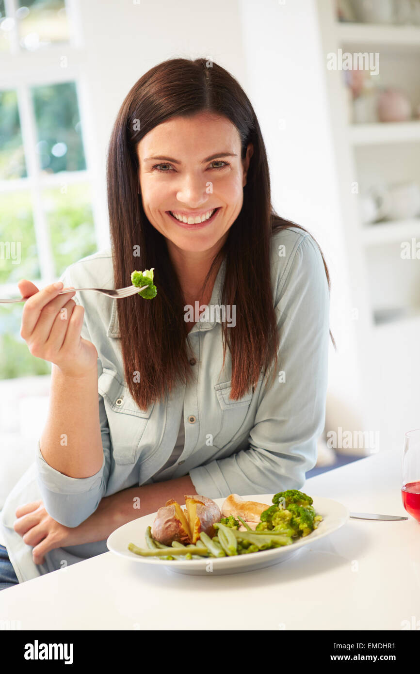 Portrait Of Woman Eating Healthy Meal In Kitchen Stock Photo - Alamy