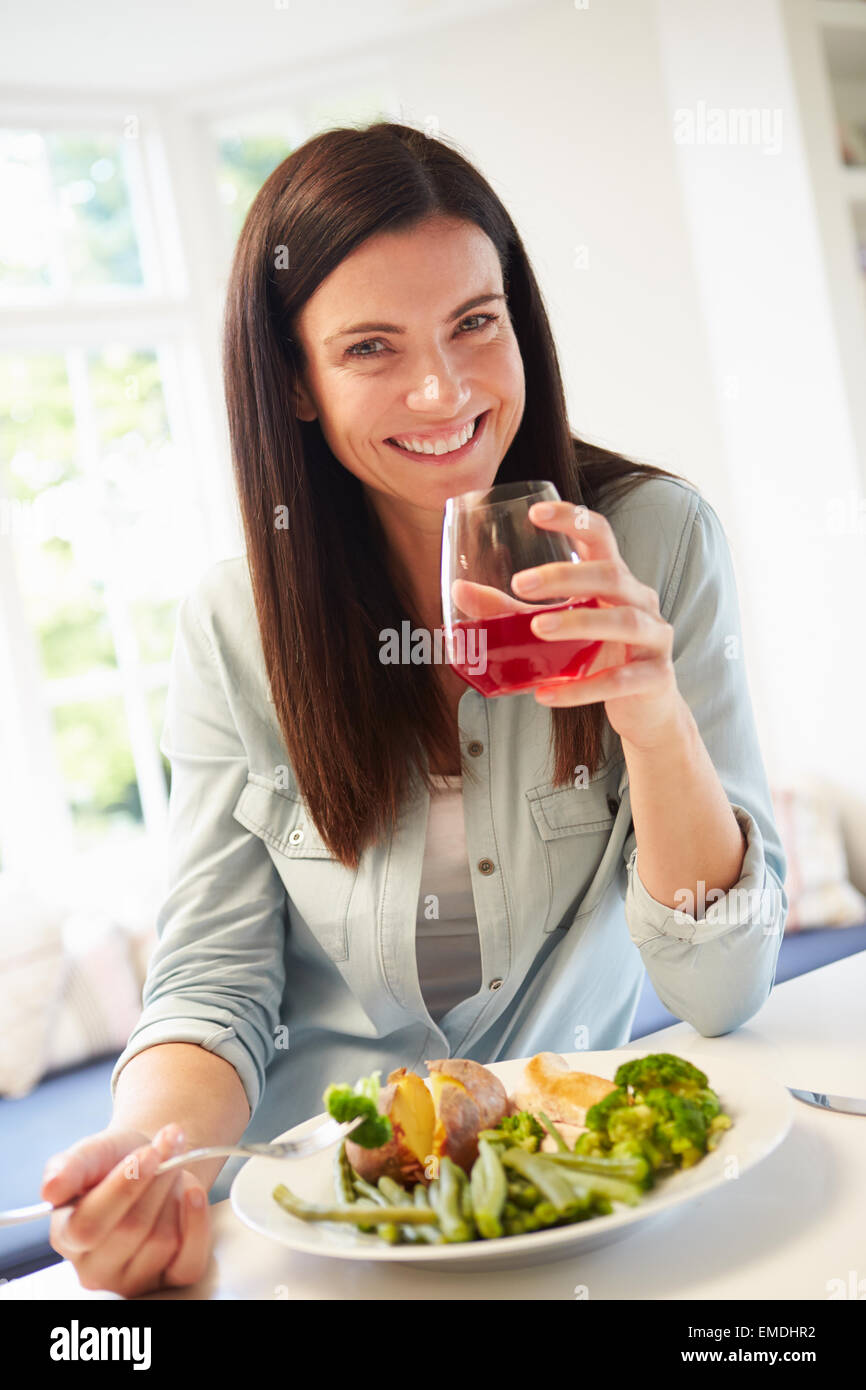 Portrait Of Woman Eating Healthy Meal In Kitchen Stock Photo - Alamy
