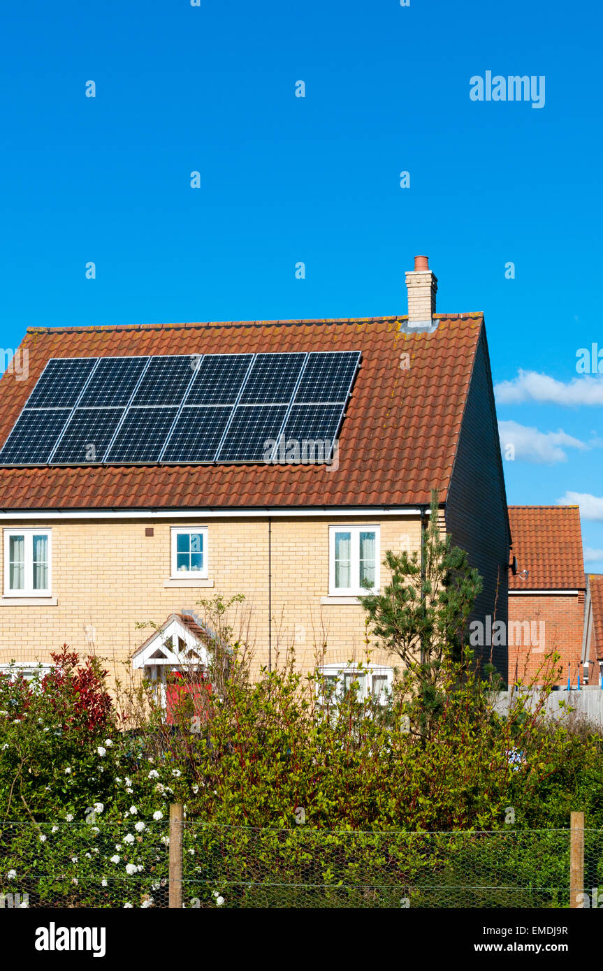 Solar photovoltaic panel array on house roof against a blue sky Stock ...