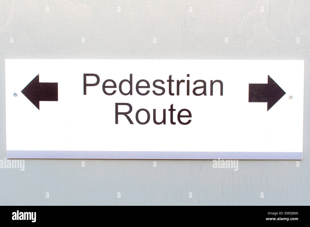 Pedestrian route direction notice board on wooden background Stock ...