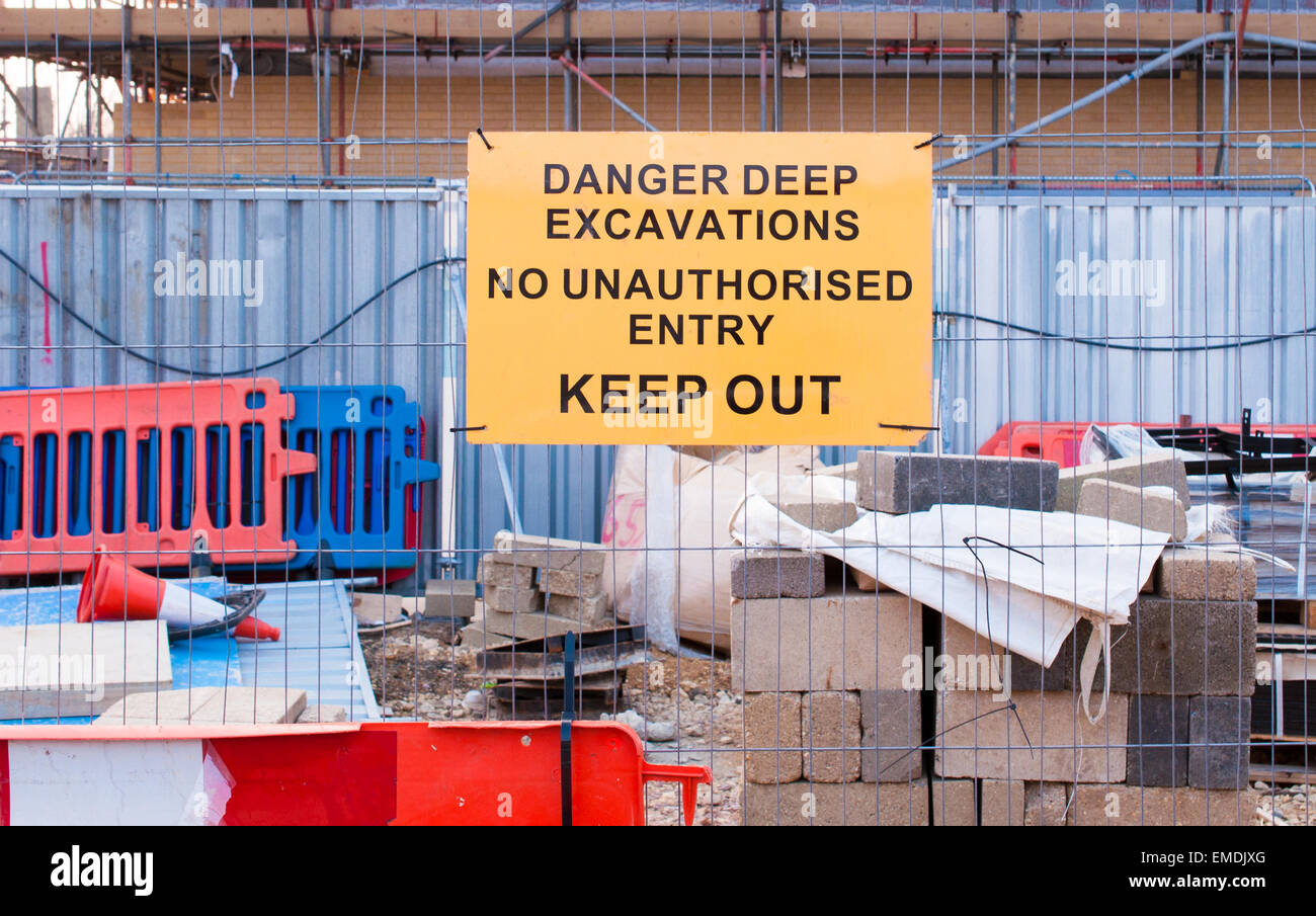 Construction material in the background warning sign on metal fence ...