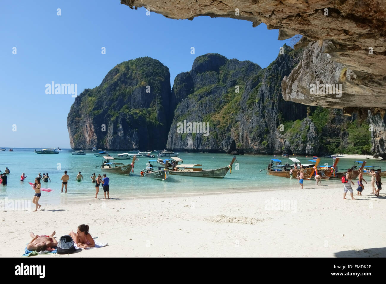 Boats, tourists, sand and sea on tropical Maya Beach, Koh Phi Phi Leh, looking out to the ...
