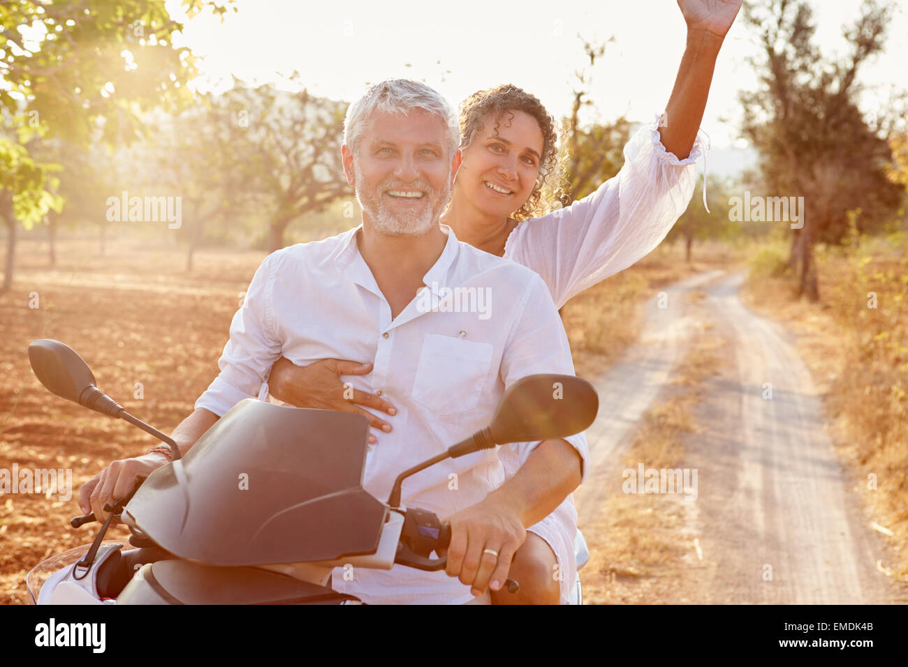 Mature couple riding motor scooter hi-res stock photography and images ...