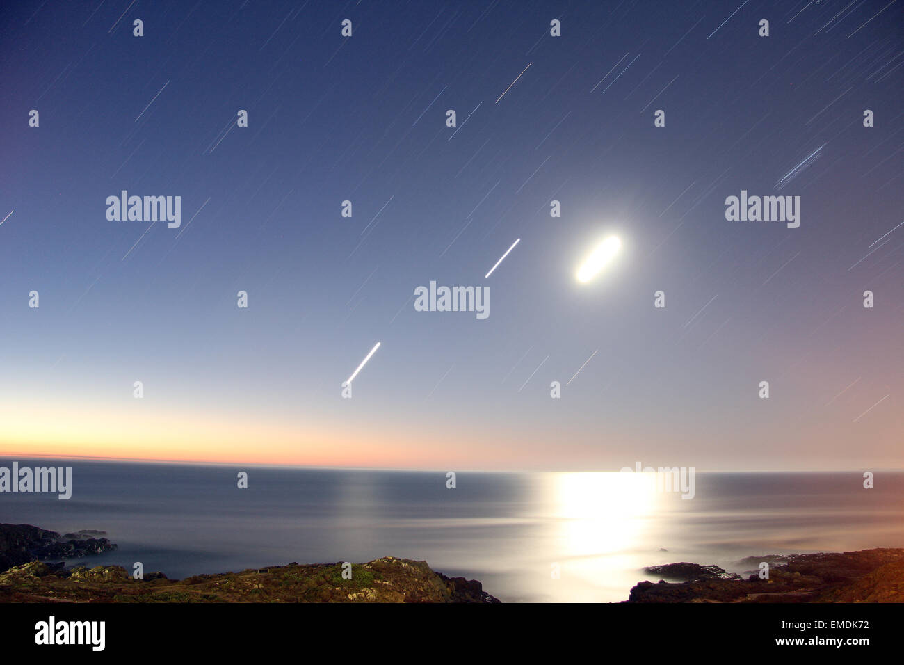 Stars and moon long exposure over ocean Stock Photo - Alamy