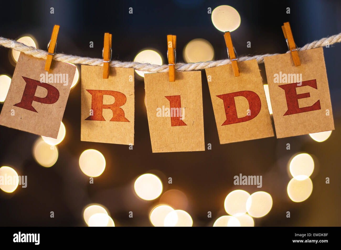 The word PRIDE printed on clothespin clipped cards in front of ...