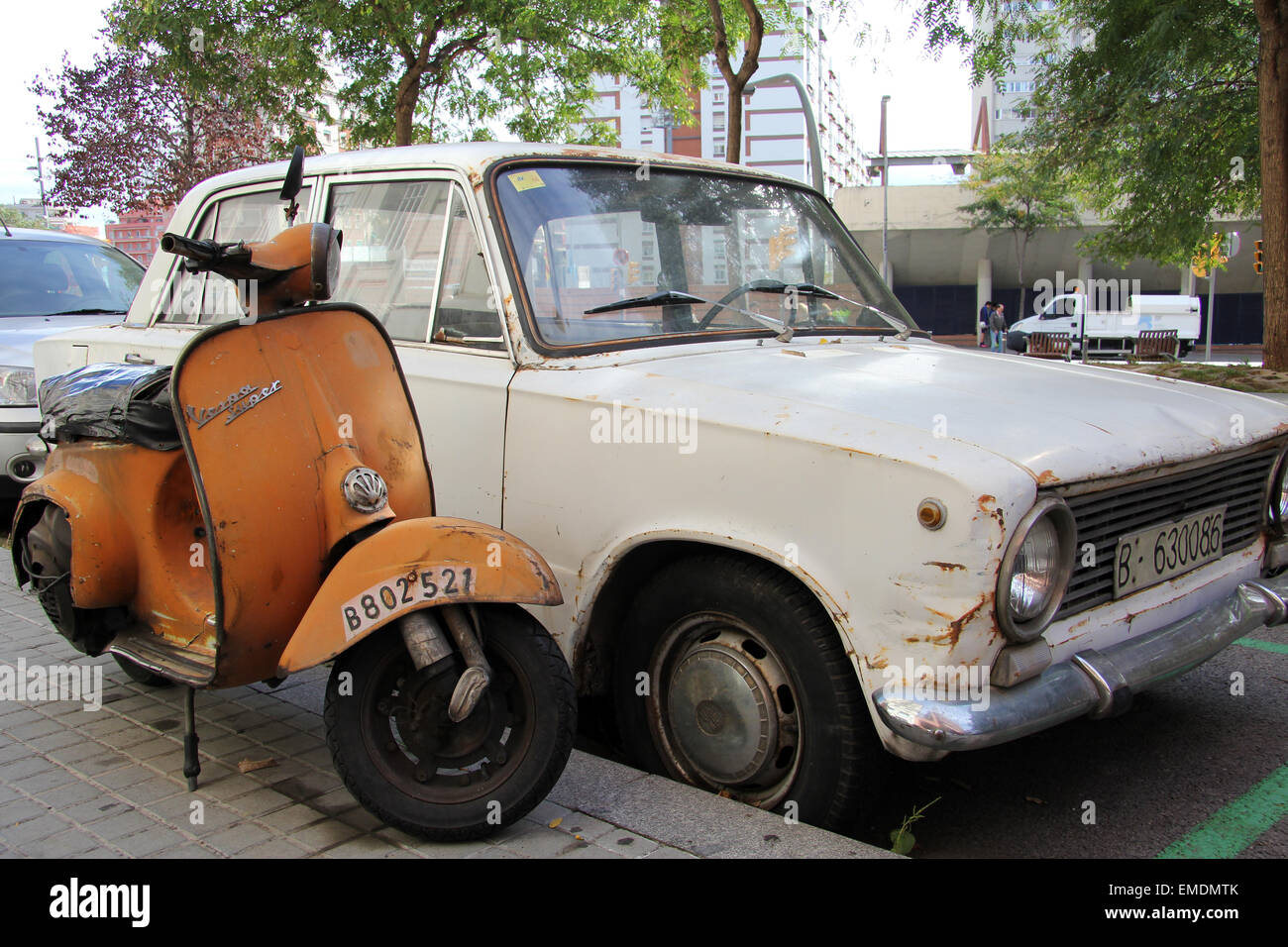Rusted car and scooter Barcelona Stock Photo - Alamy