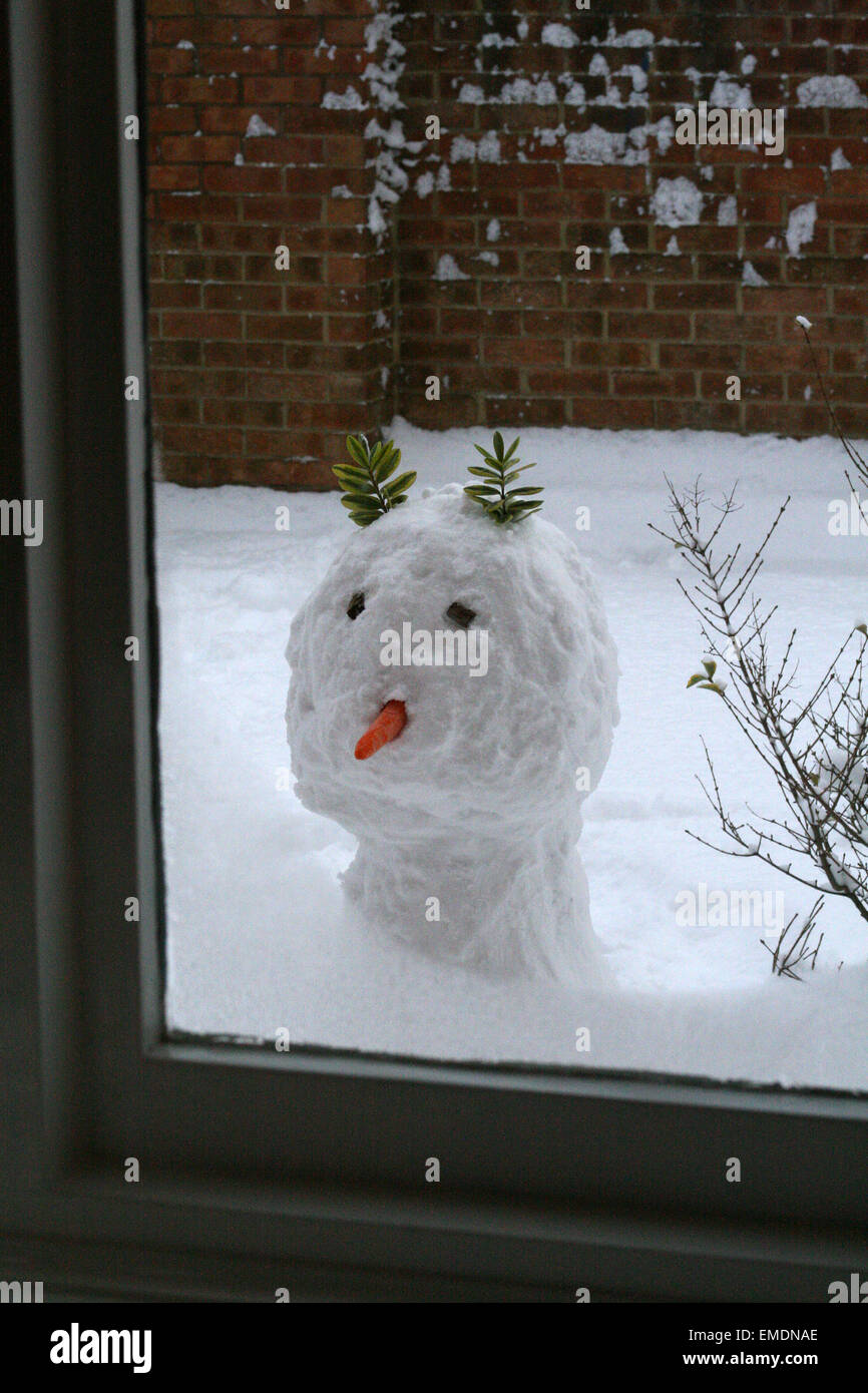 Snowman by window Stock Photo - Alamy