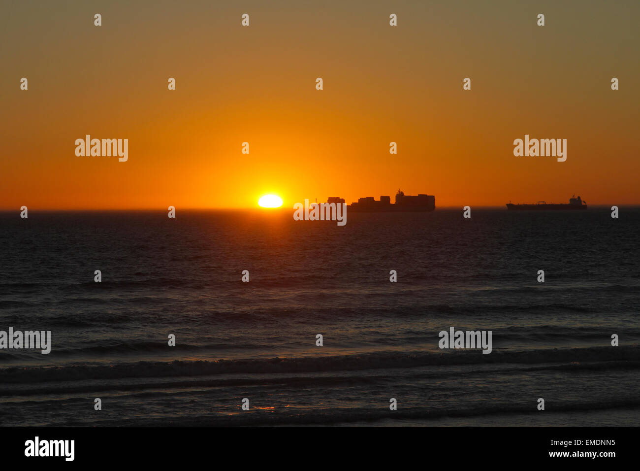 Sunset with ships Stock Photo - Alamy