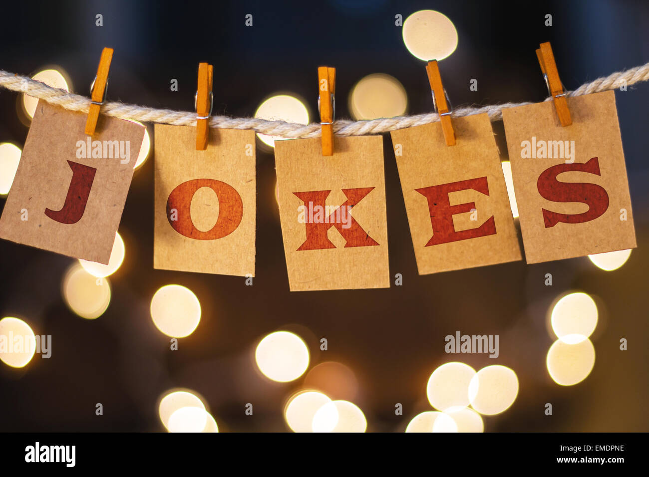 The word JOKES printed on clothespin clipped cards in front of ...