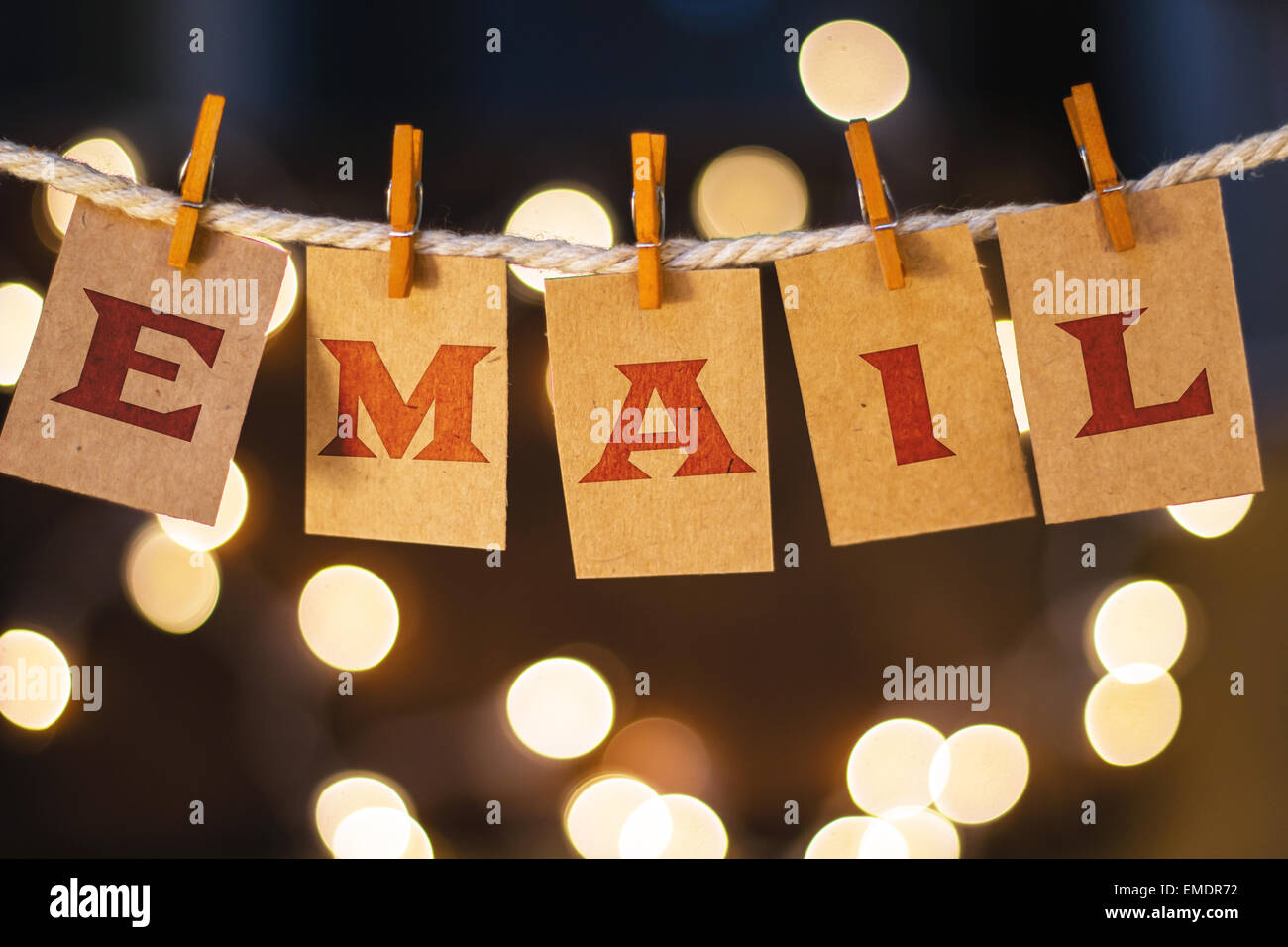 The word EMAIL printed on clothespin clipped cards in front of ...