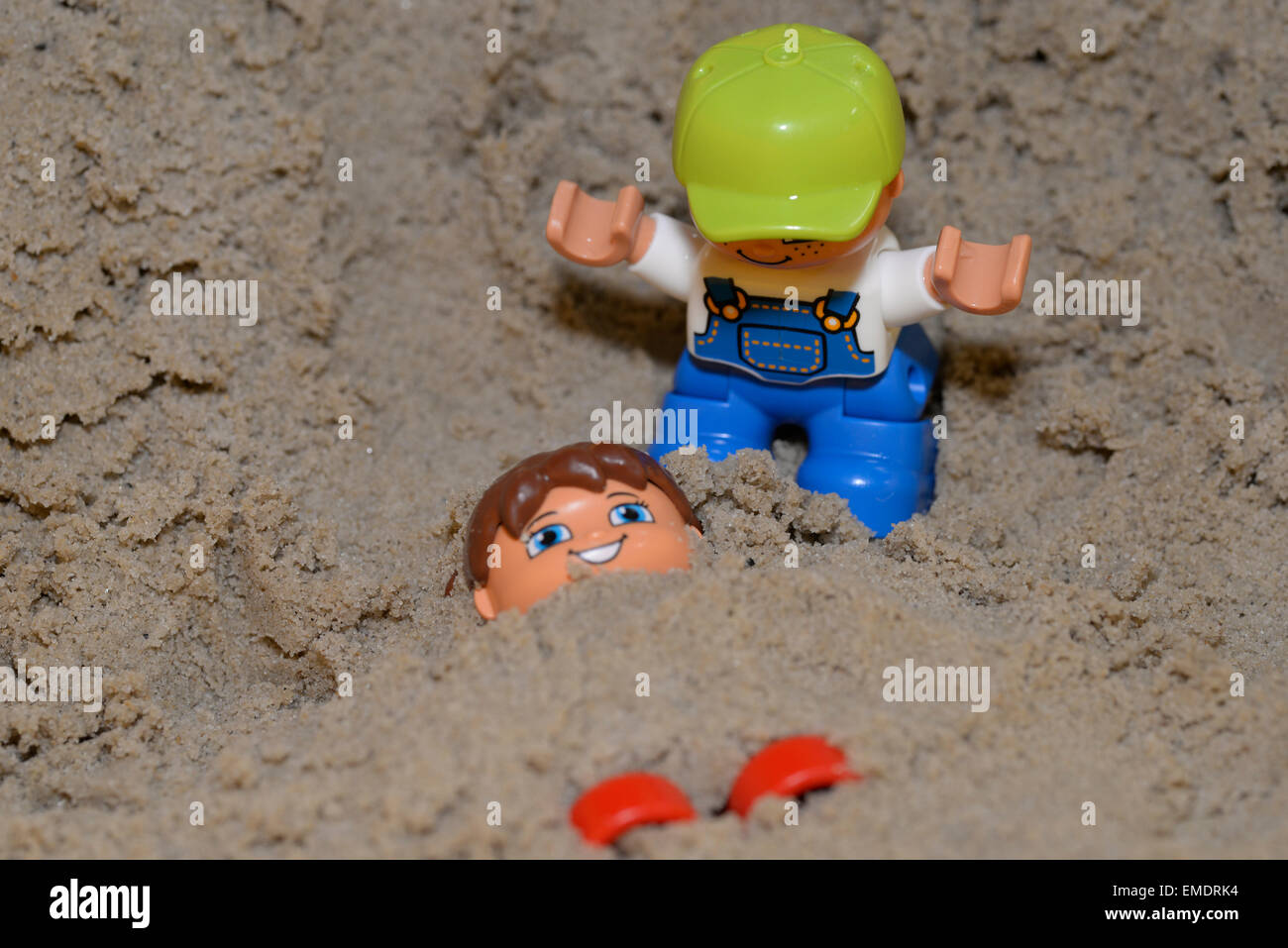 duplo lego style people in sand Stock Photo - Alamy