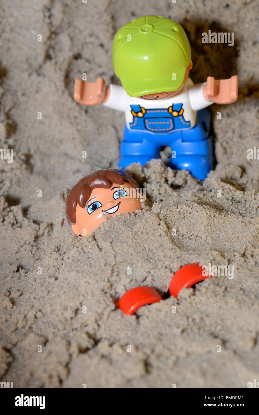 duplo lego style people in sand Stock Photo - Alamy