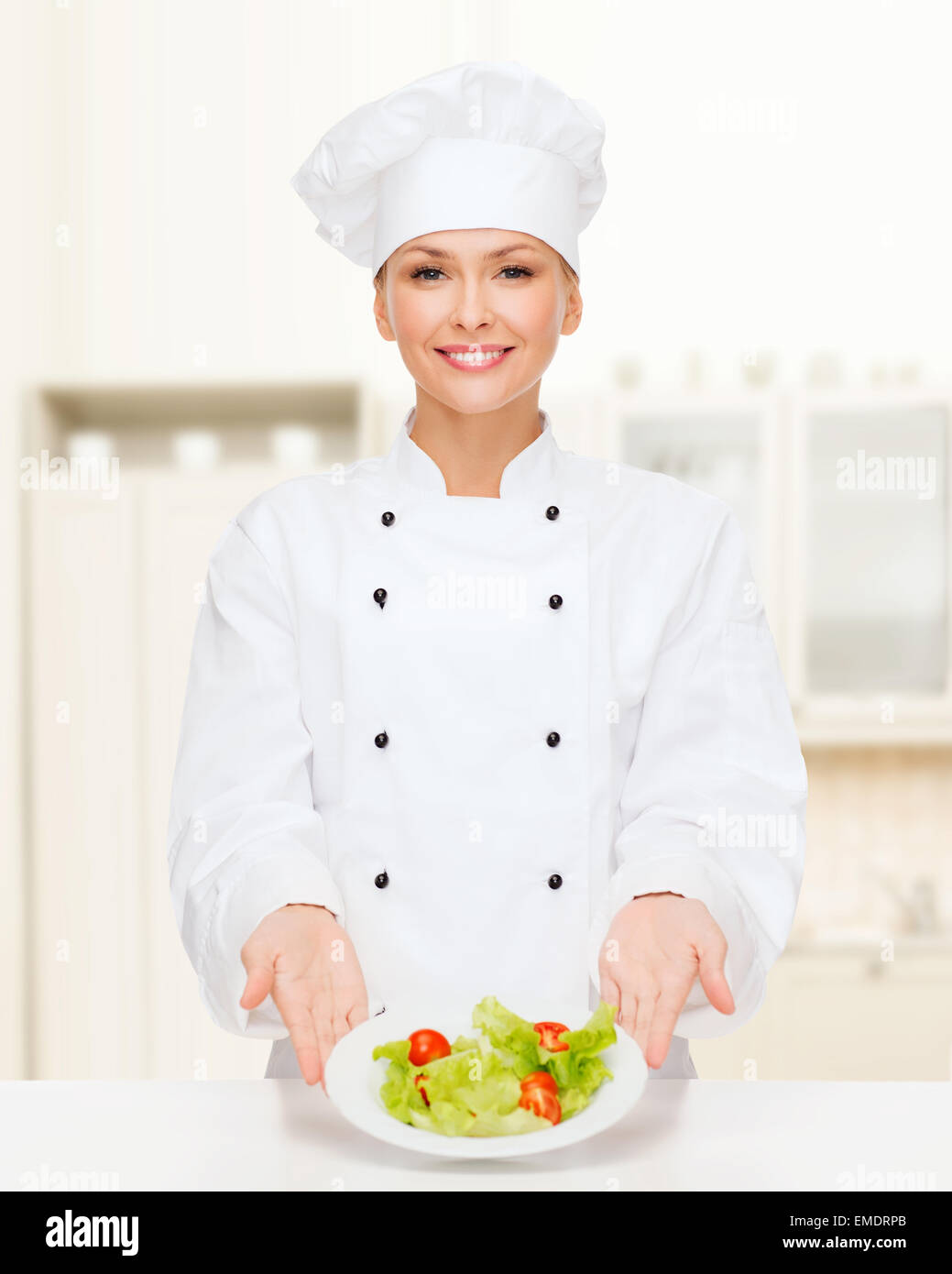 smiling female chef with salad on plate Stock Photo - Alamy