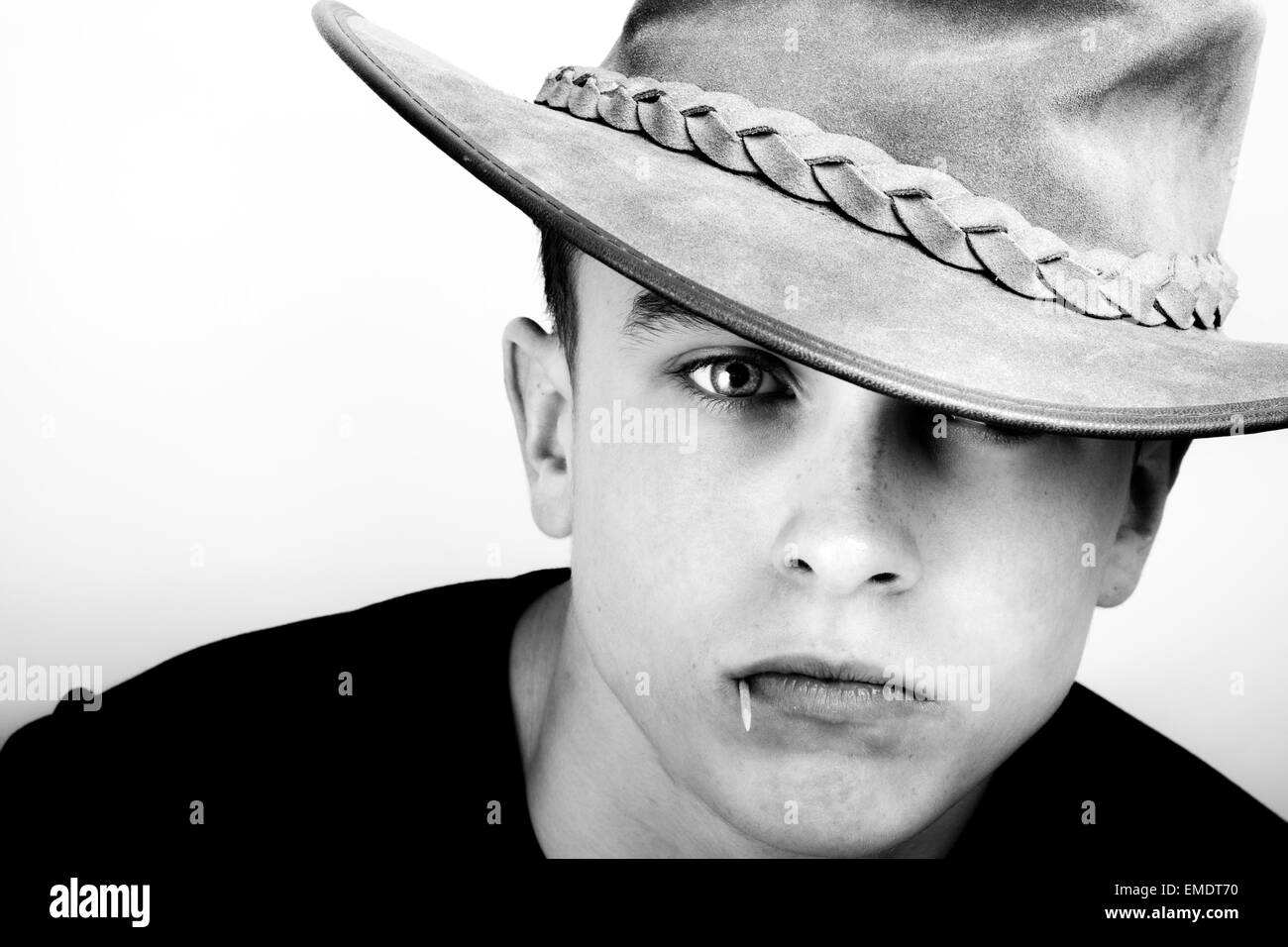 Portrait of a white British teen boy wearing a hat in black and white ...