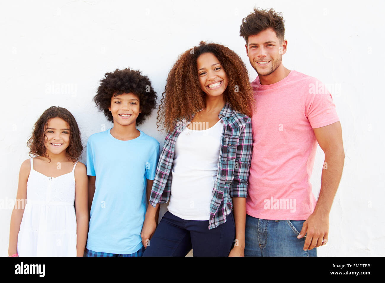 Family Standing Outdoors Against White Wall Stock Photo - Alamy