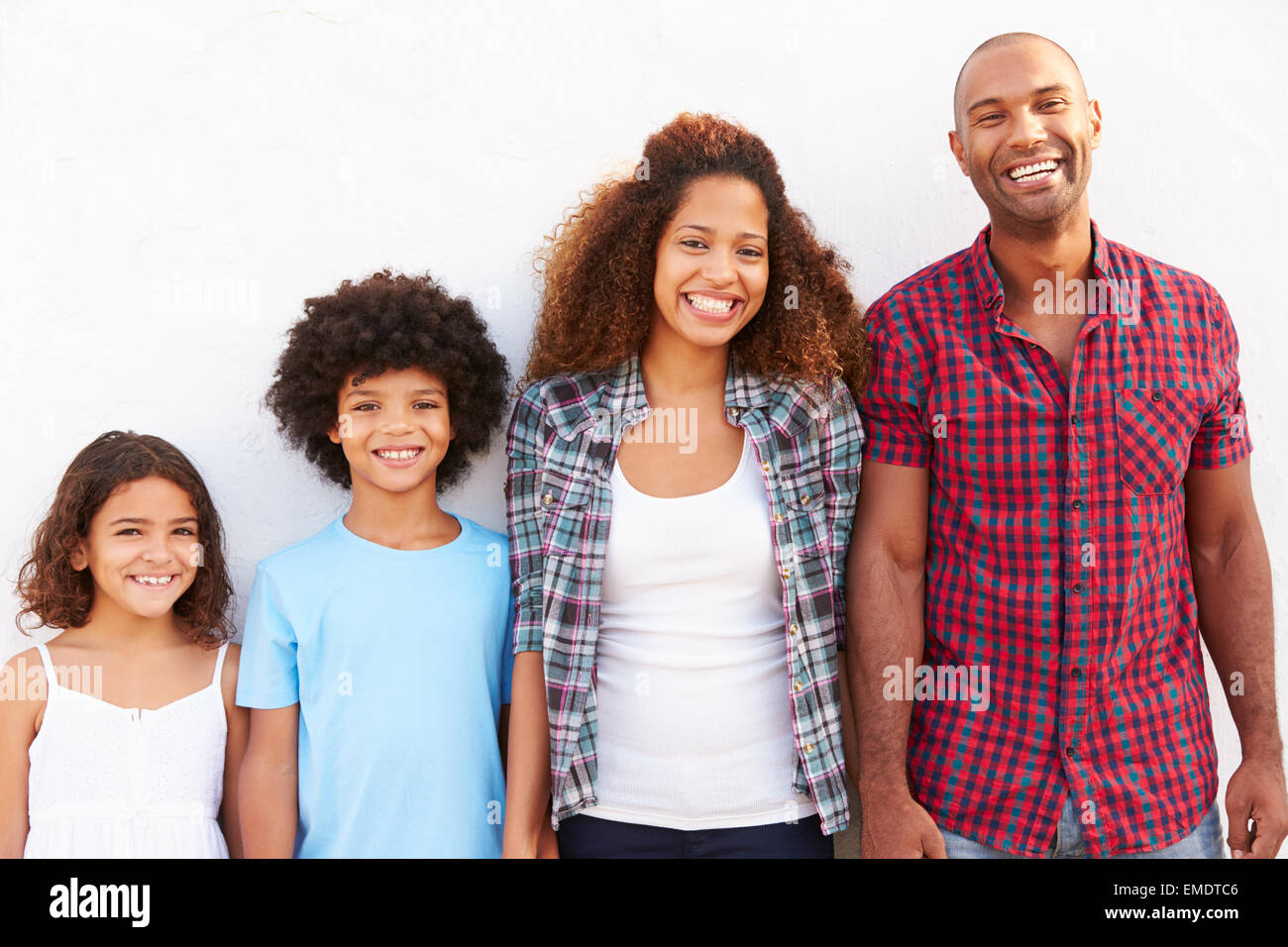 Family Standing Outdoors Against White Wall Stock Photo - Alamy
