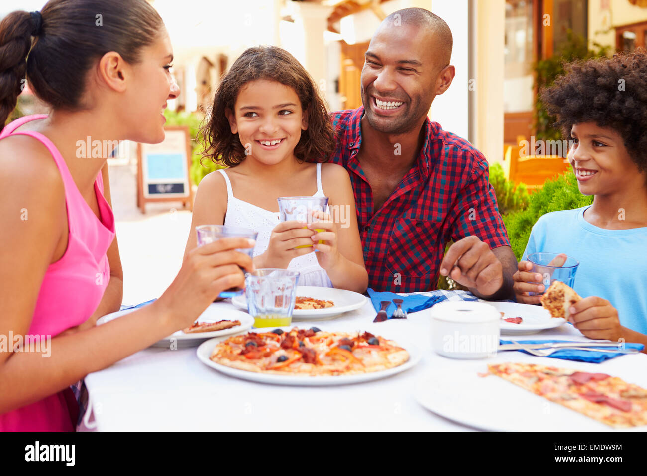 Family Eating Meal At Outdoor Restaurant Together Stock Photo - Alamy