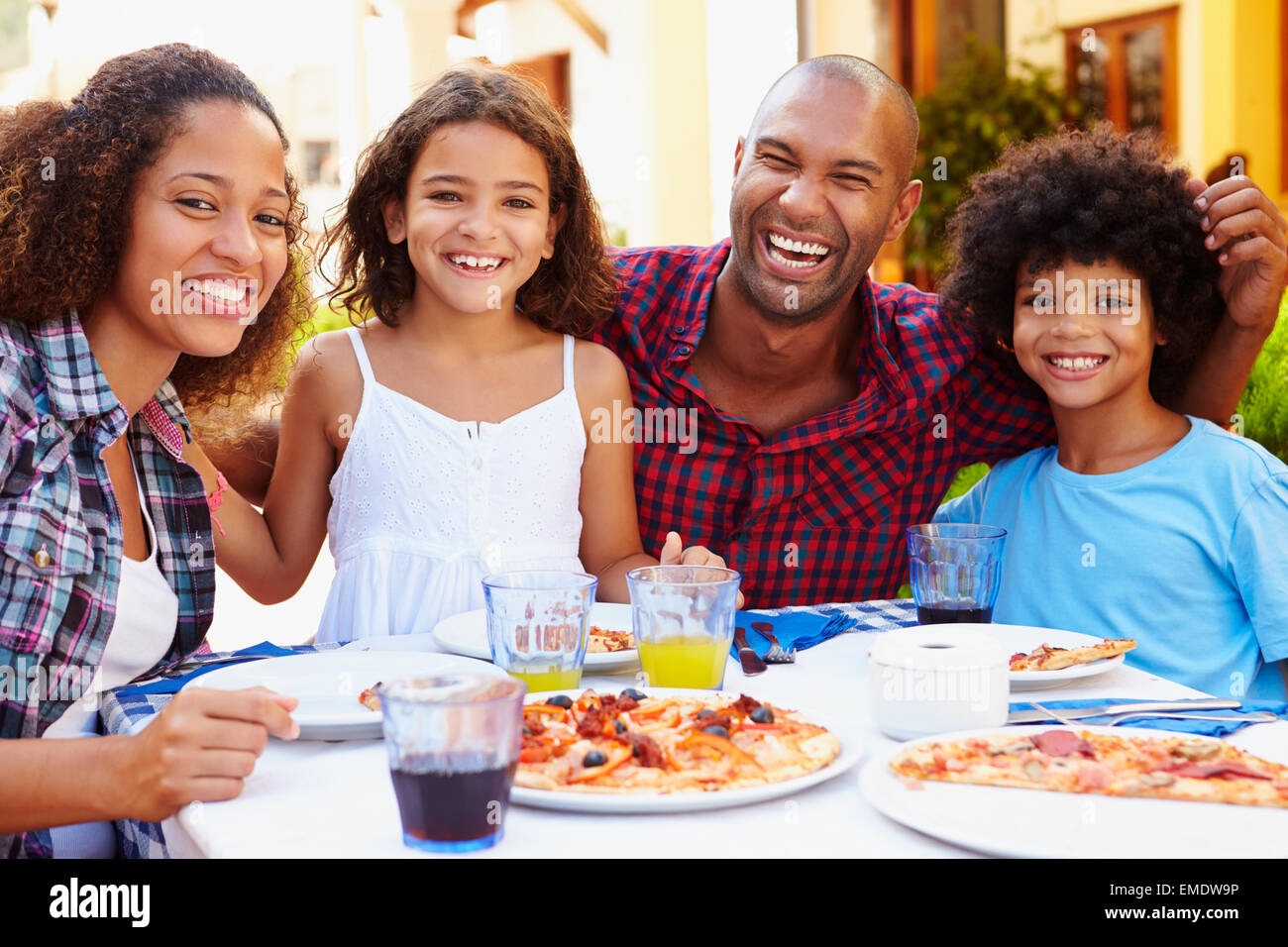 Hispanic family eating pizza together hi-res stock photography and ...