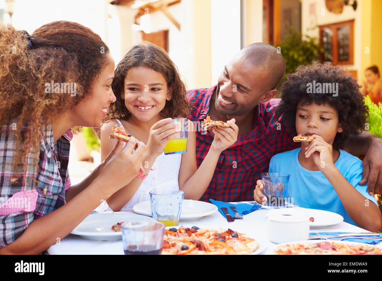 Family Eating Meal At Outdoor Restaurant Together Stock Photo - Alamy