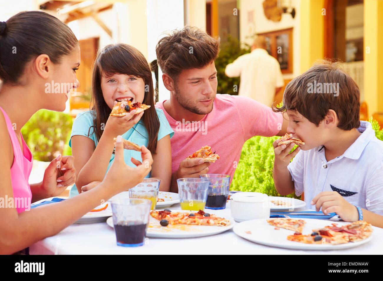 Hispanic family eating pizza together hi-res stock photography and ...