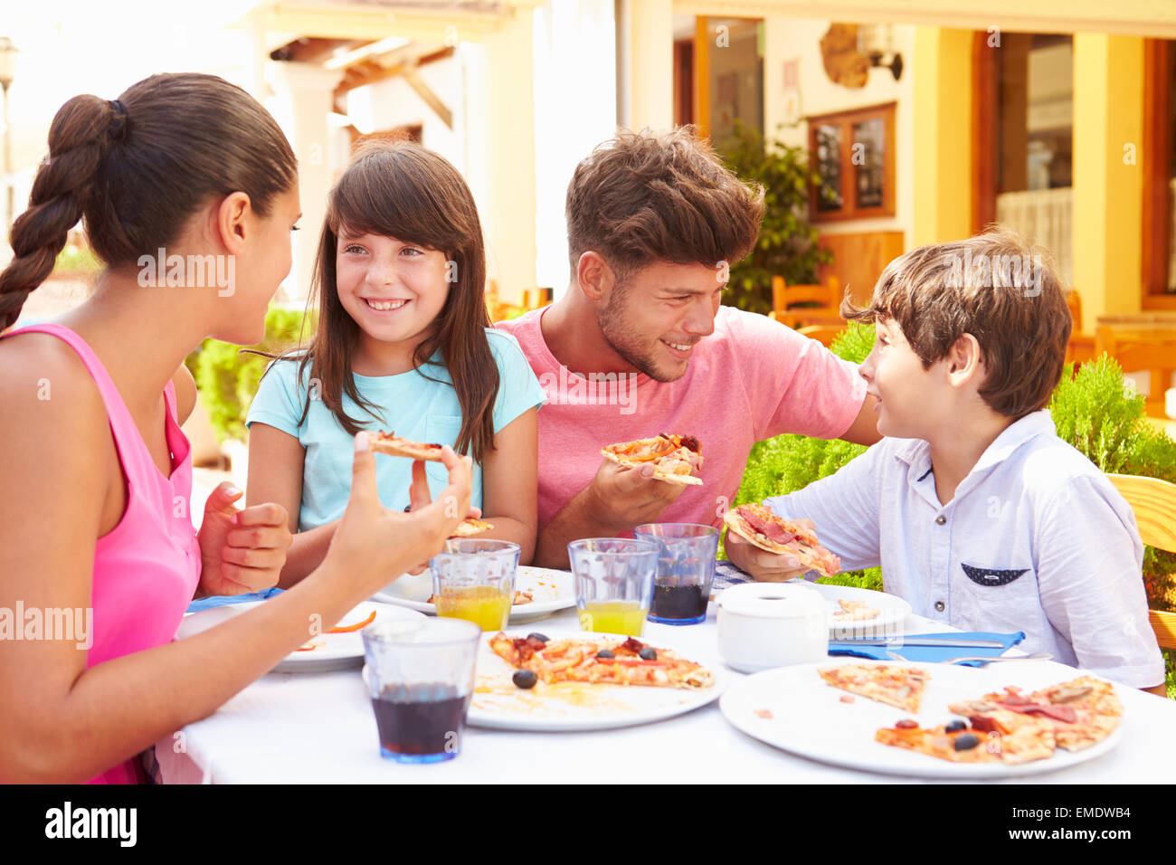 Family Eating Meal At Outdoor Restaurant Together Stock Photo - Alamy
