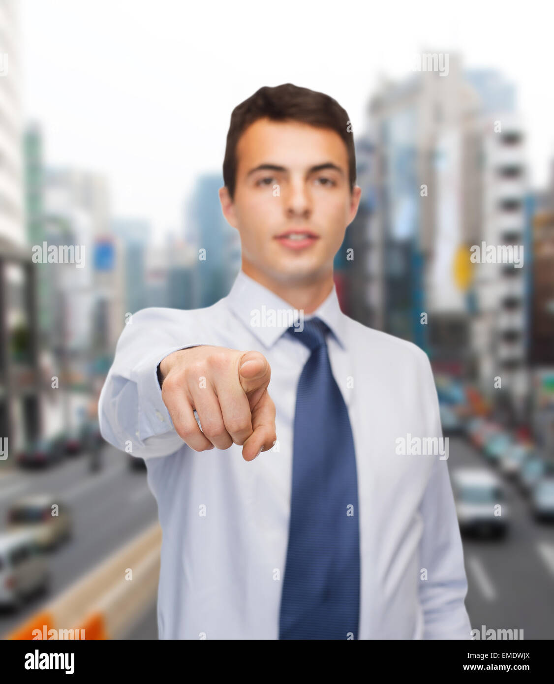 friendly young buisnessman pointing finger Stock Photo - Alamy