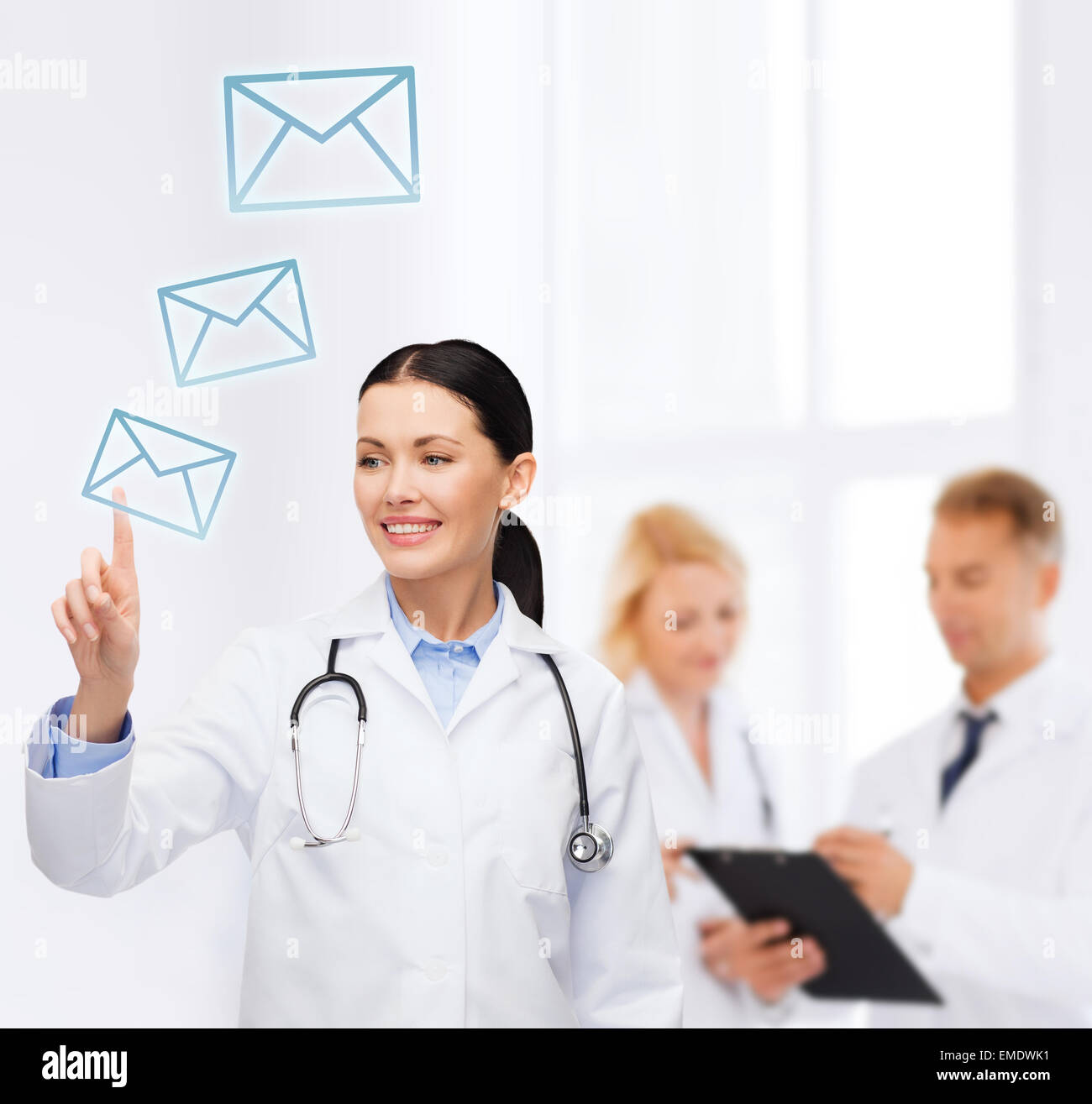 smiling female doctor pointing to envelope Stock Photo - Alamy