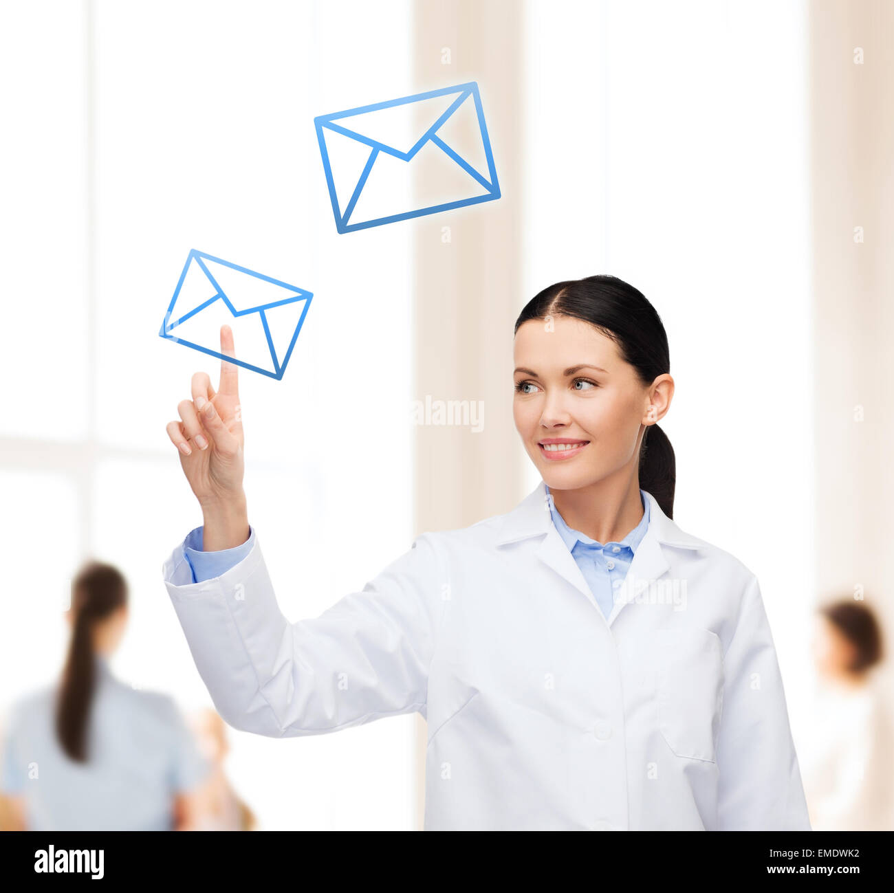 smiling female doctor pointing to envelope Stock Photo - Alamy