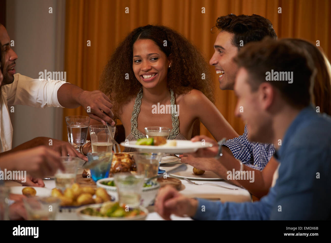 Group Of Friends Enjoying Dinner Party At Home Together Stock Photo - Alamy