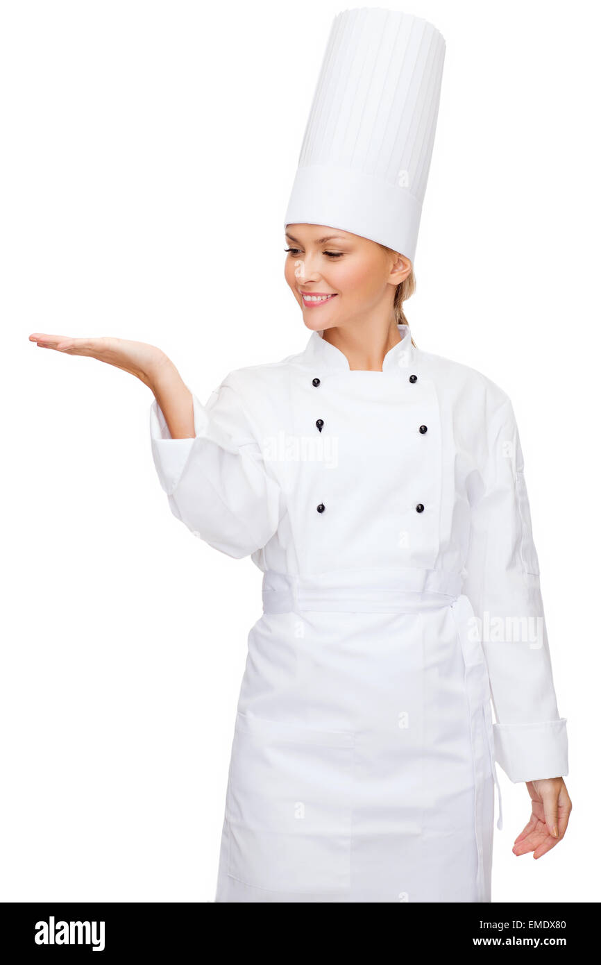 smiling female chef holding something on hand Stock Photo - Alamy