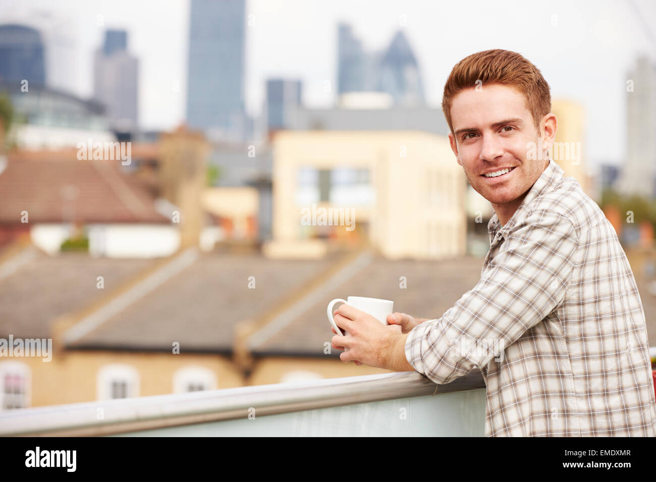 Man Relaxing Outdoors On Rooftop Garden Drinking Coffee Stock Photo - Alamy
