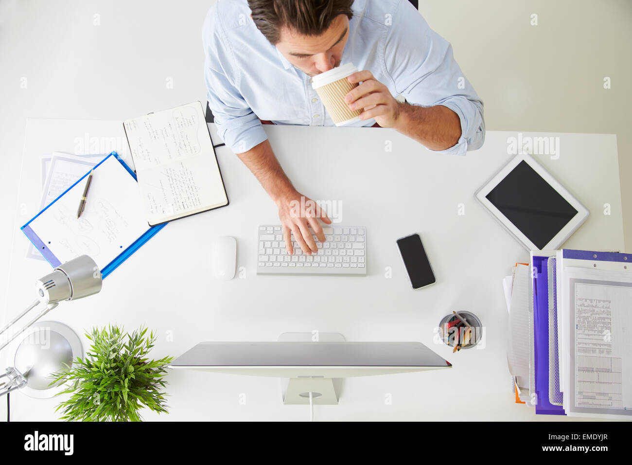 Overhead View Of Businessman Working At Computer In Office Stock Photo ...