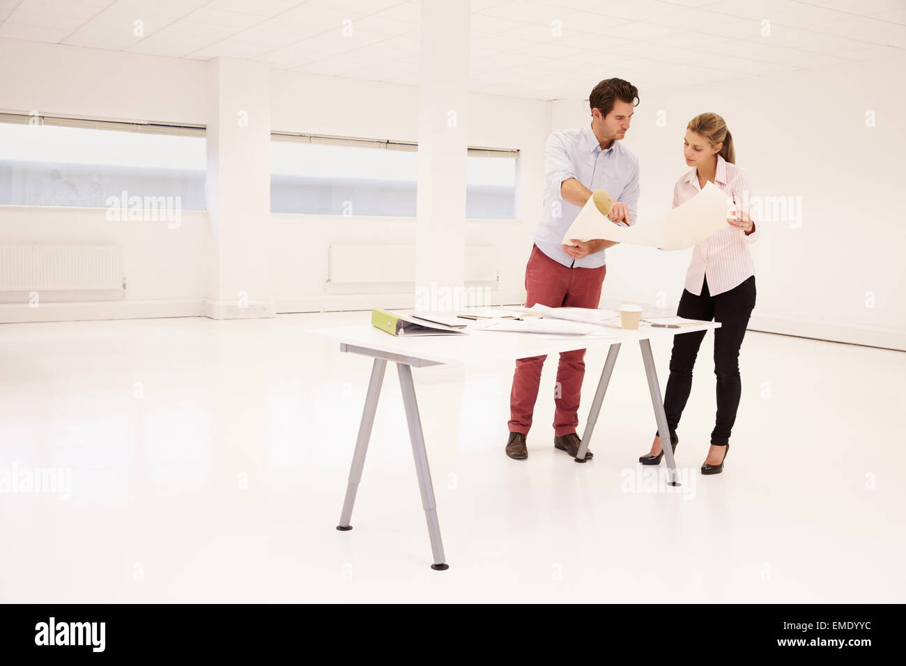 Architects Planning Layout Of Empty Office Space Stock Photo - Alamy