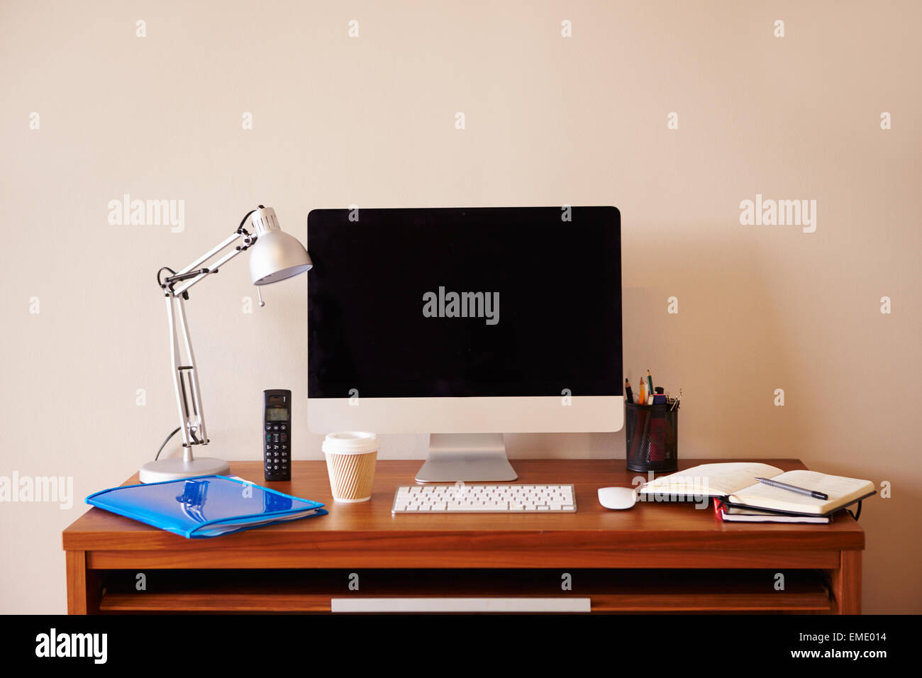 Computer On Desk In Home Office Stock Photo - Alamy