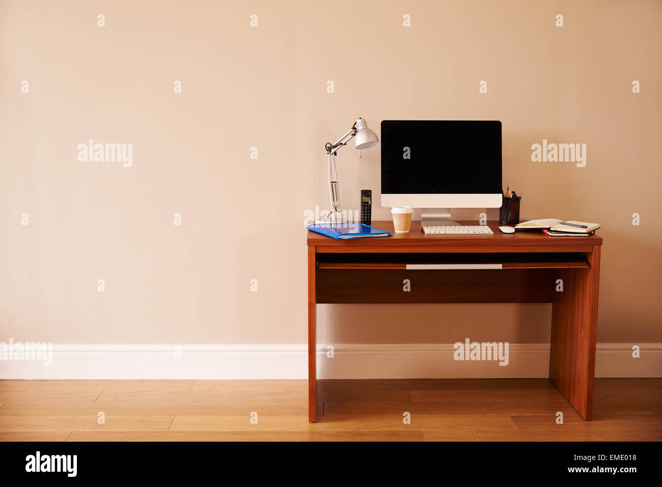 Computer On Desk In Home Office Stock Photo - Alamy