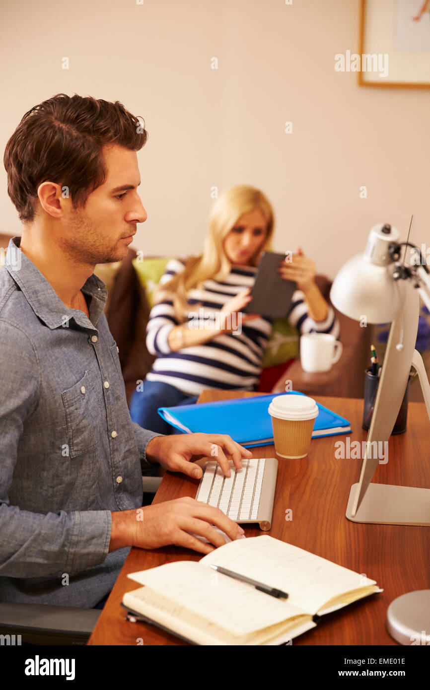 Man Sitting At Desk Working At Computer In Home Office Stock Photo - Alamy