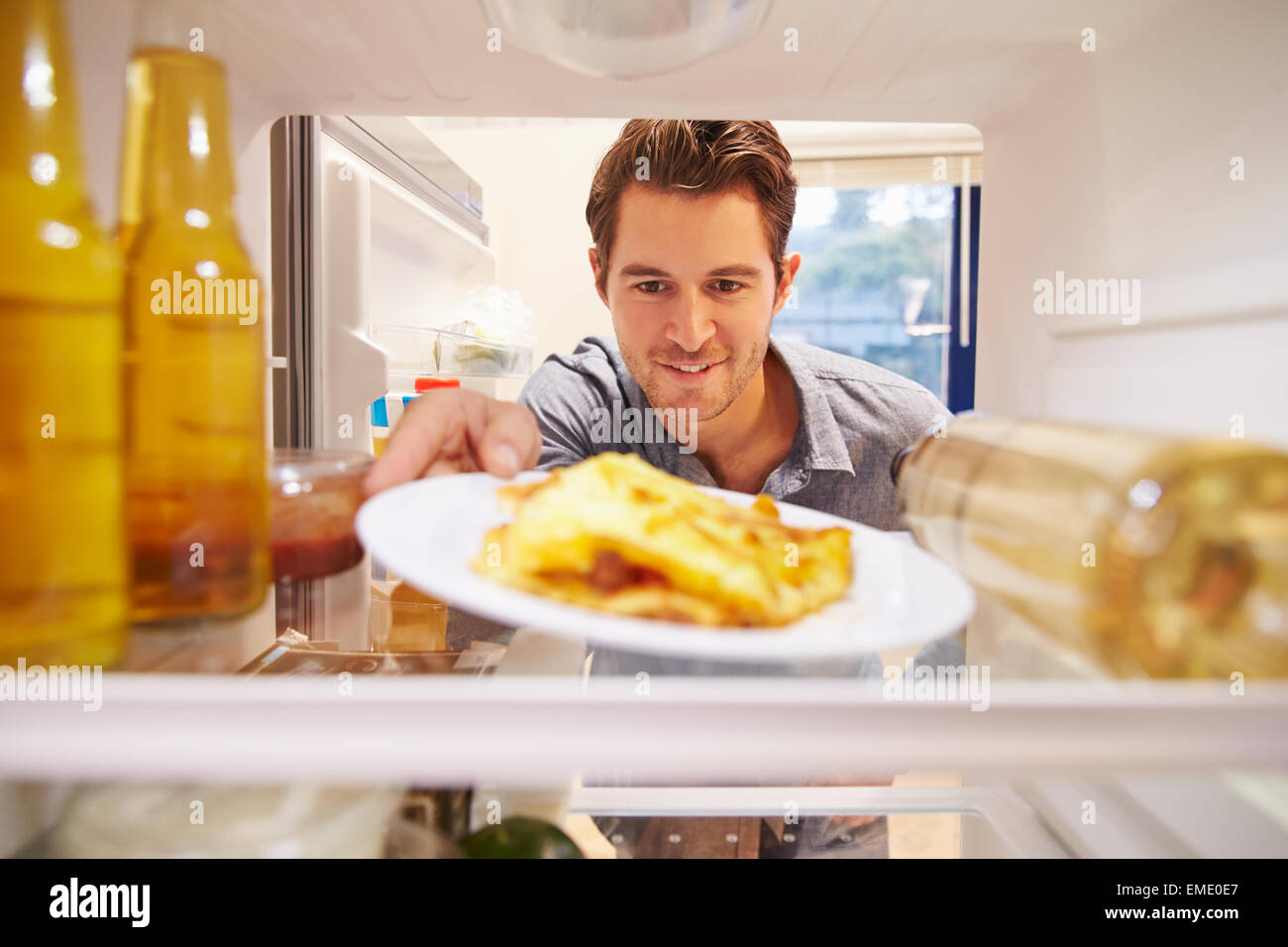 Man Looking Inside Fridge Full Of Unhealthy Food Stock Photo - Alamy