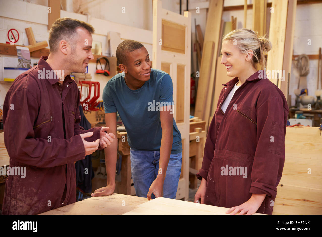 Carpenter Talking To Apprentices In Carpentry Workshop Stock Photo - Alamy