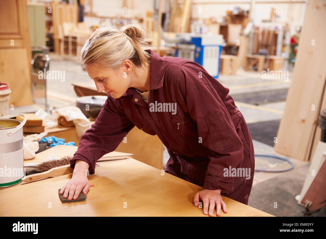 Female Apprentice Finishing Wood In Carpentry Workshop Stock Photo - Alamy