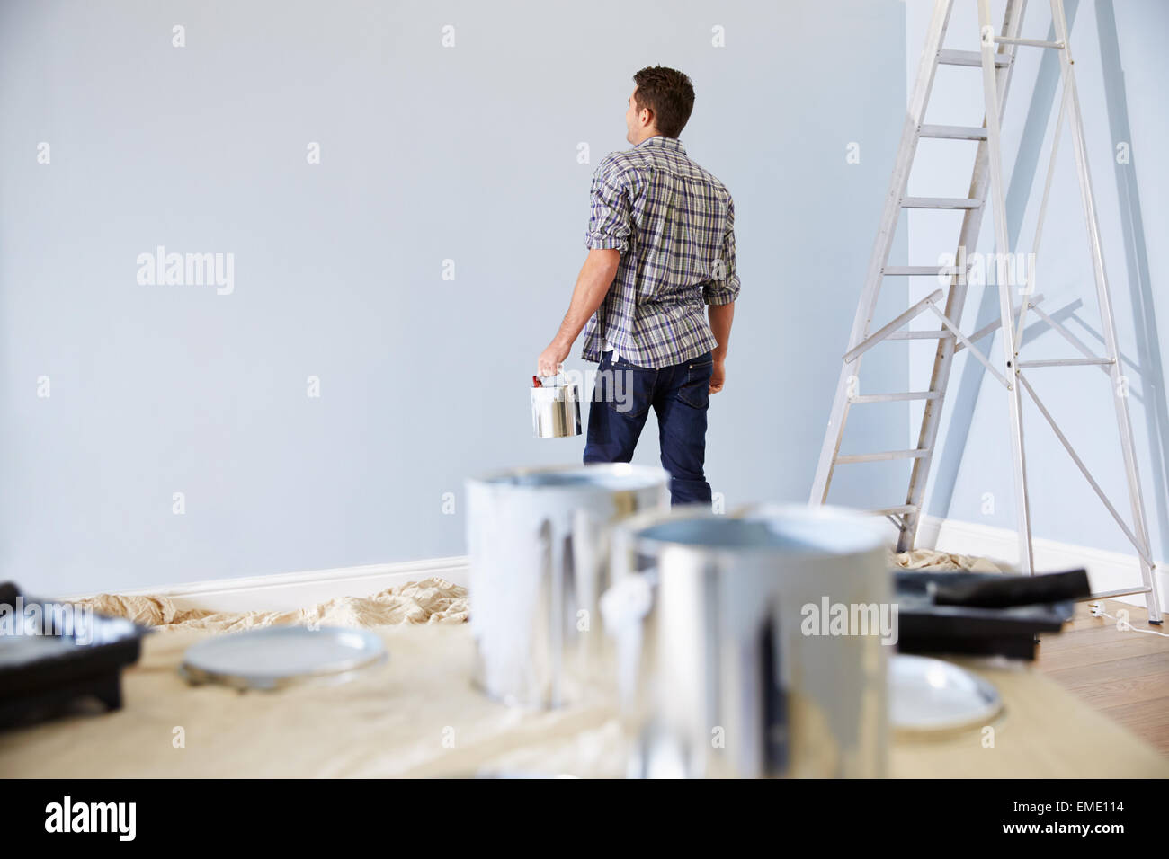 Man Decorating Nursery For New Baby Stock Photo - Alamy