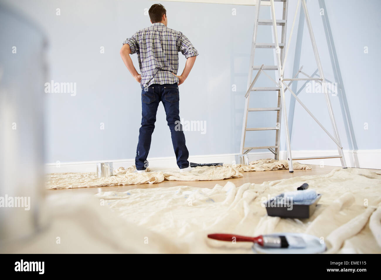 Man Decorating Nursery For New Baby Stock Photo - Alamy