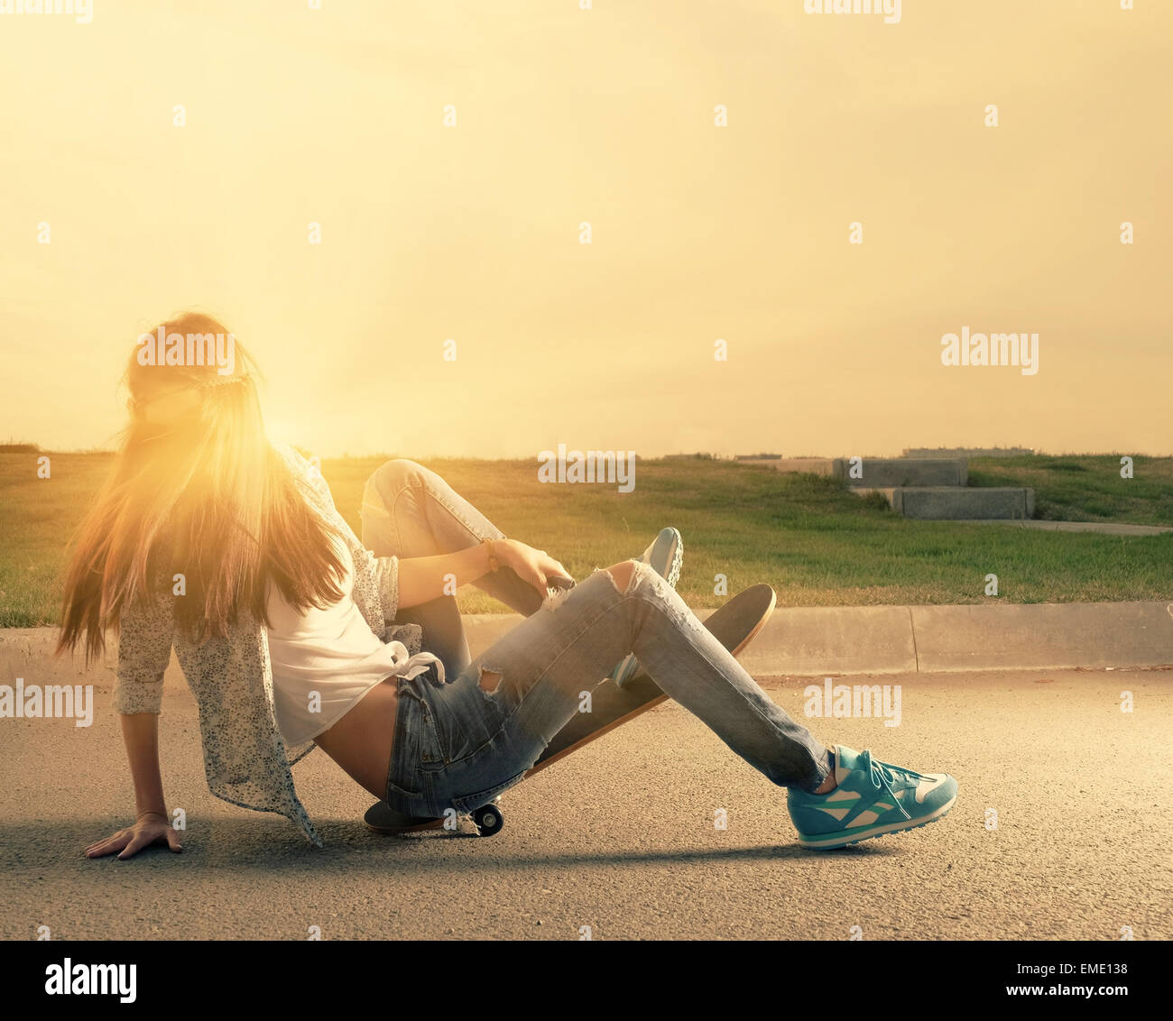 Young Girl Falling off Skateboard backlit by sunset. Copyspace. Image ...