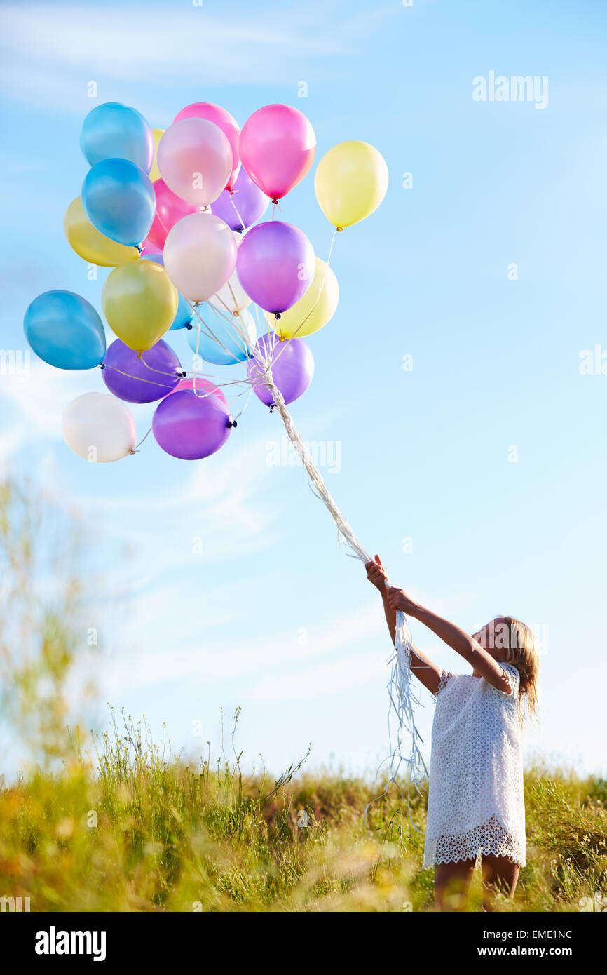 Two Young Girls Holding Bunch Of Colorful Balloons Outdoors Stock Photo ...