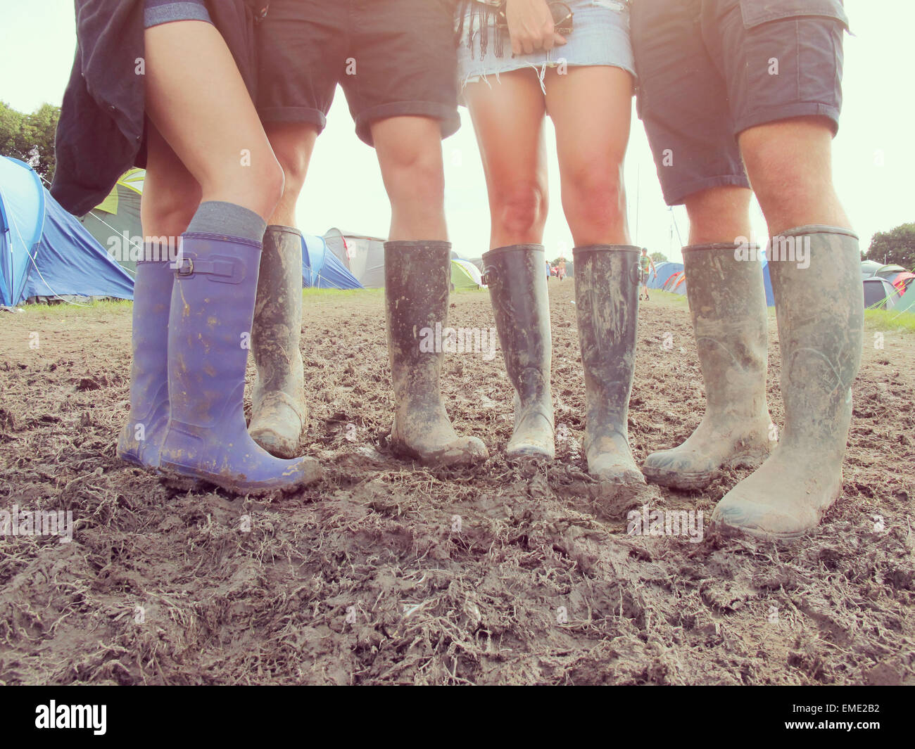 Close Up Of Friends In Wellington Boots Walking To Festival Stock Photo ...