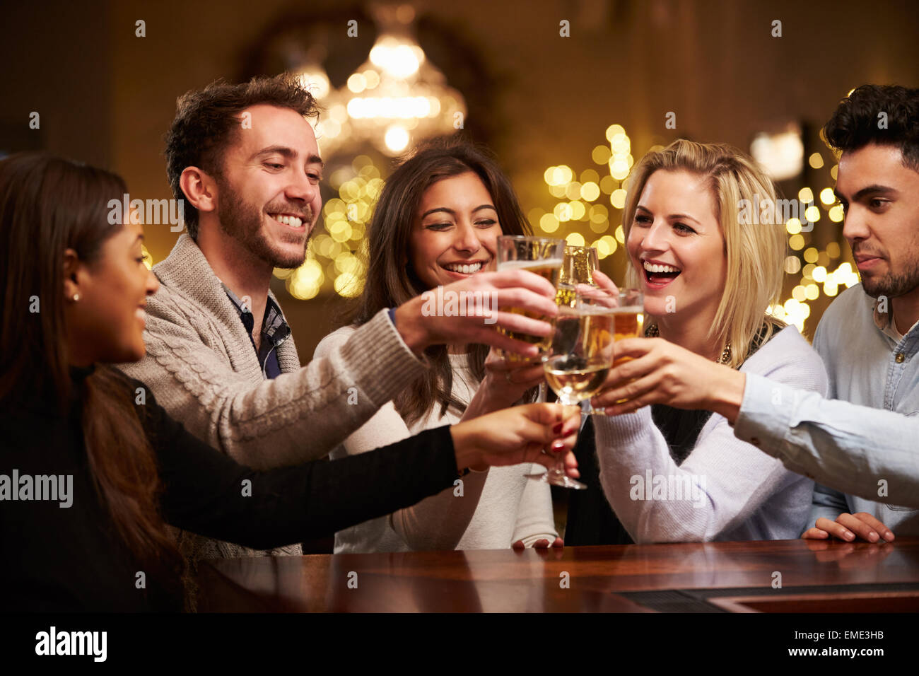 Group Of Friends Enjoying Evening Drinks In Bar Stock Photo - Alamy