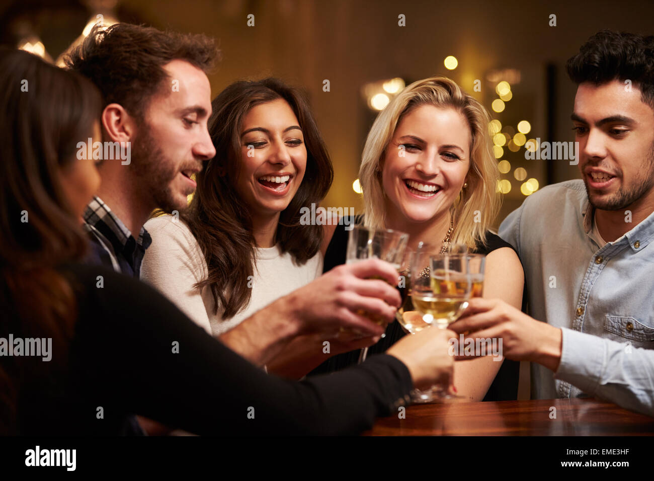 Group Of Friends Enjoying Evening Drinks In Bar Stock Photo - Alamy