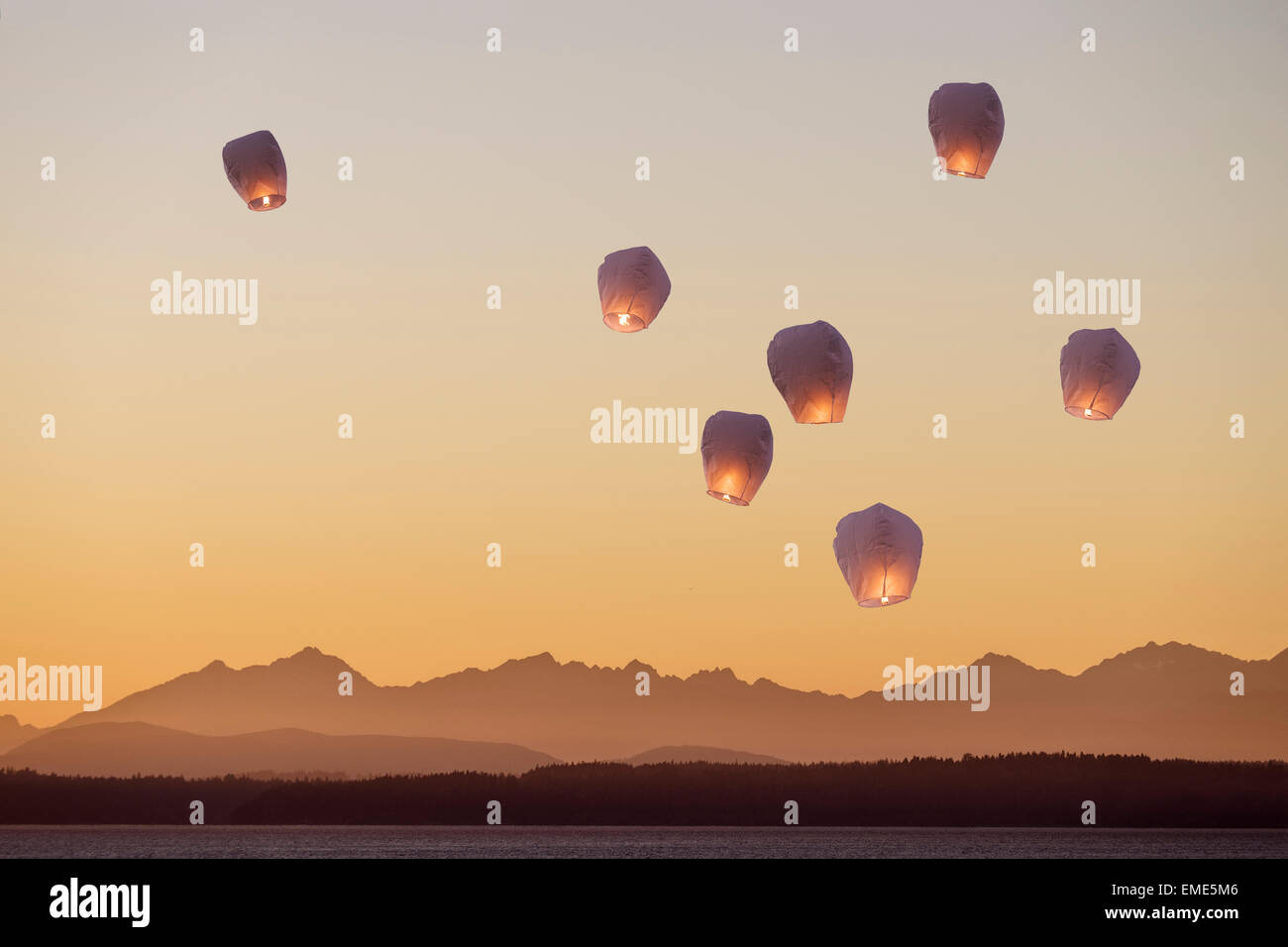 A group of flying lanterns being released into the nightsky Stock Photo ...